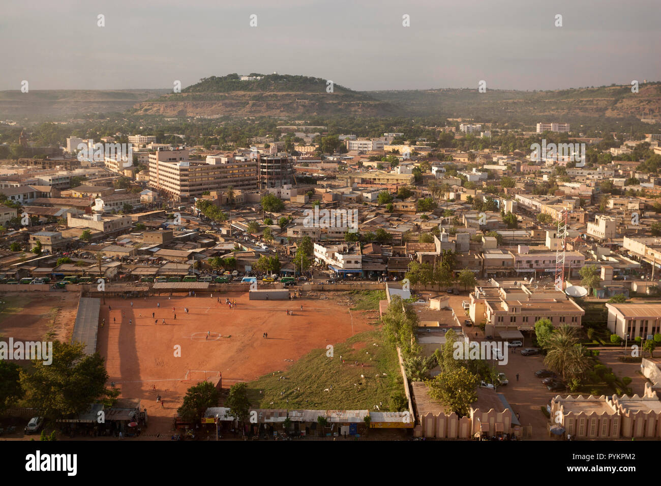 Landscape view of Bamako with a red soil soccer field in foreground ...