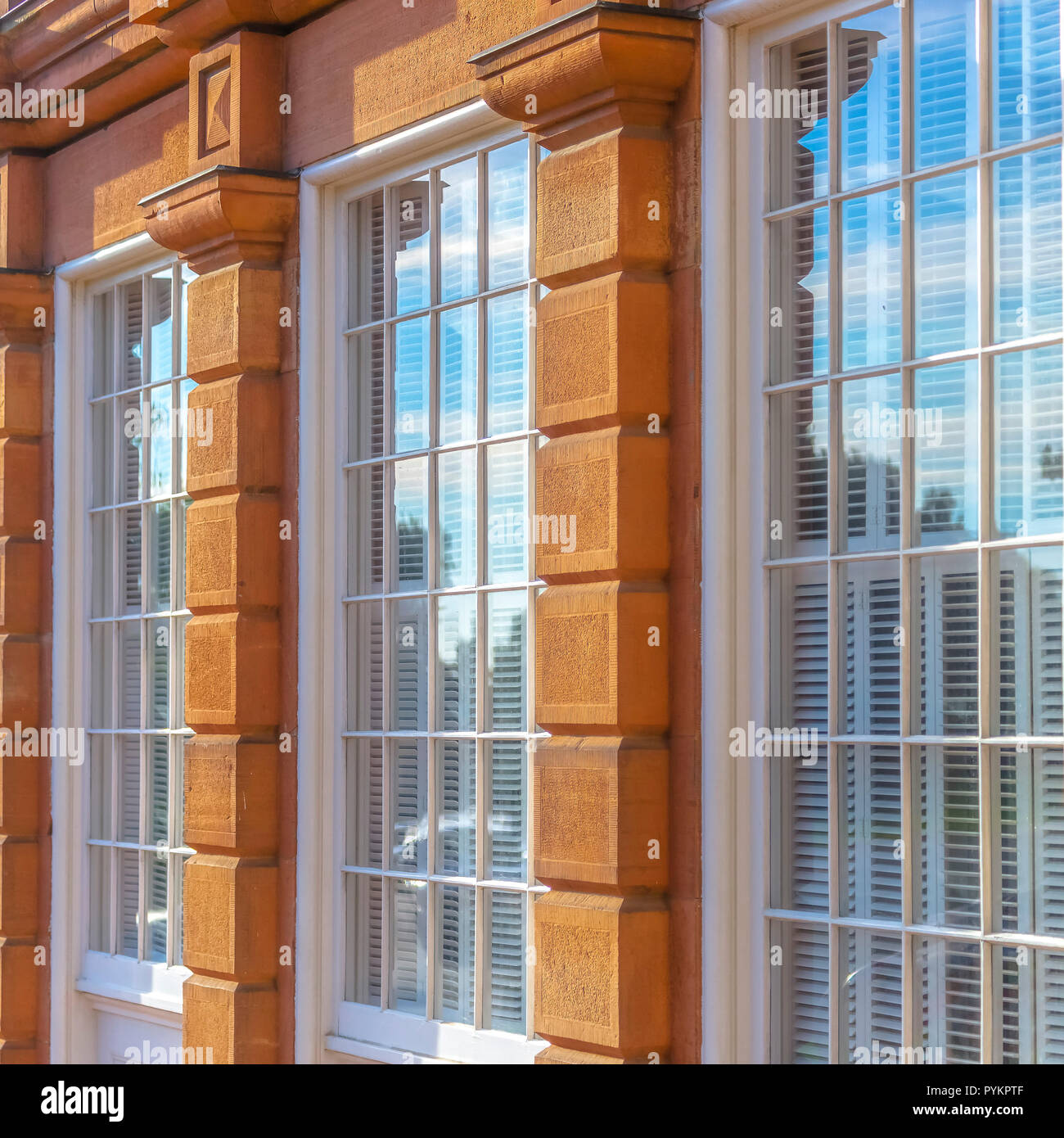 Reflective glass windows of a brown building Stock Photo - Alamy