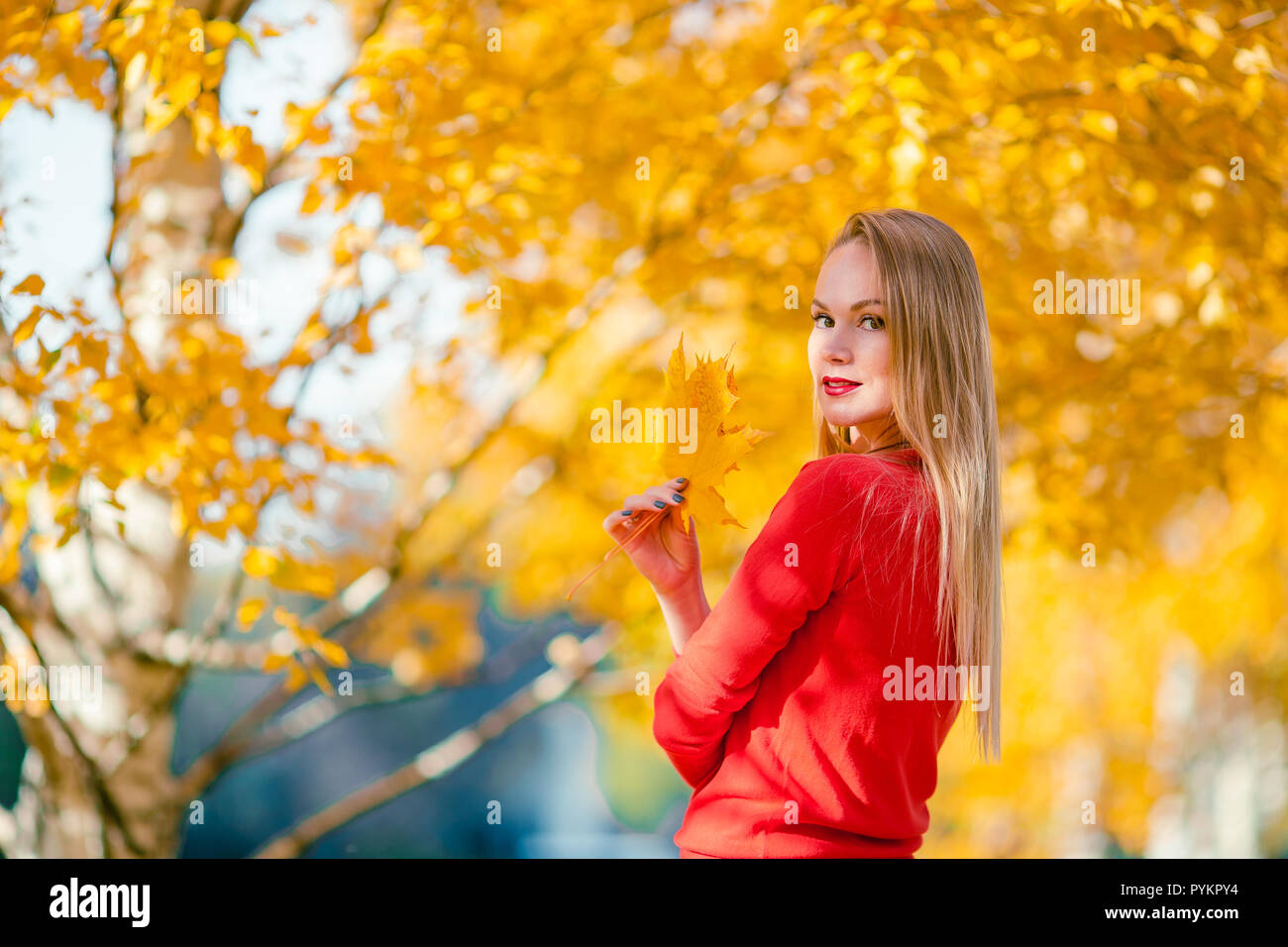 Fall concept - beautiful woman drinking coffee in autumn park under ...