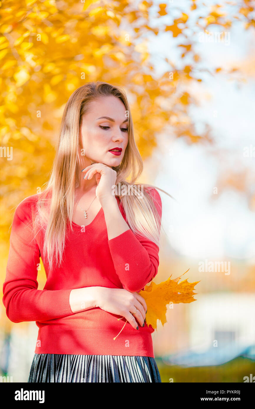 Fall concept - beautiful woman drinking coffee in autumn park under ...