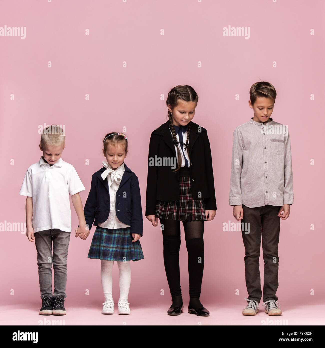 Cute smiling happy stylish children on pink background. Beautiful ...