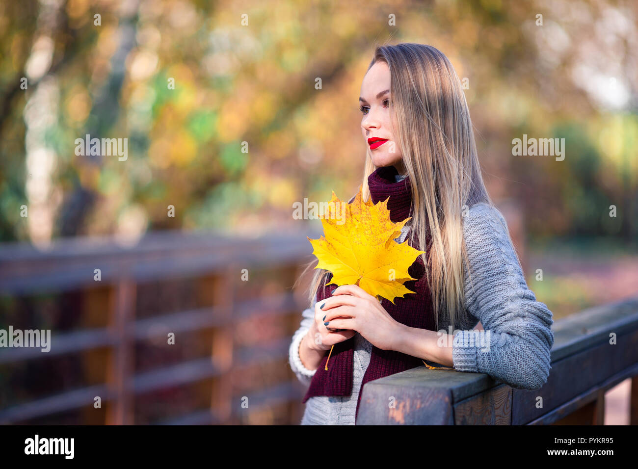 Fall concept - beautiful woman drinking coffee in autumn park under ...