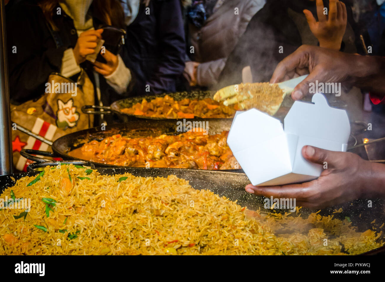 Hand serve food in a box rice and eastern meat Stock Photo - Alamy