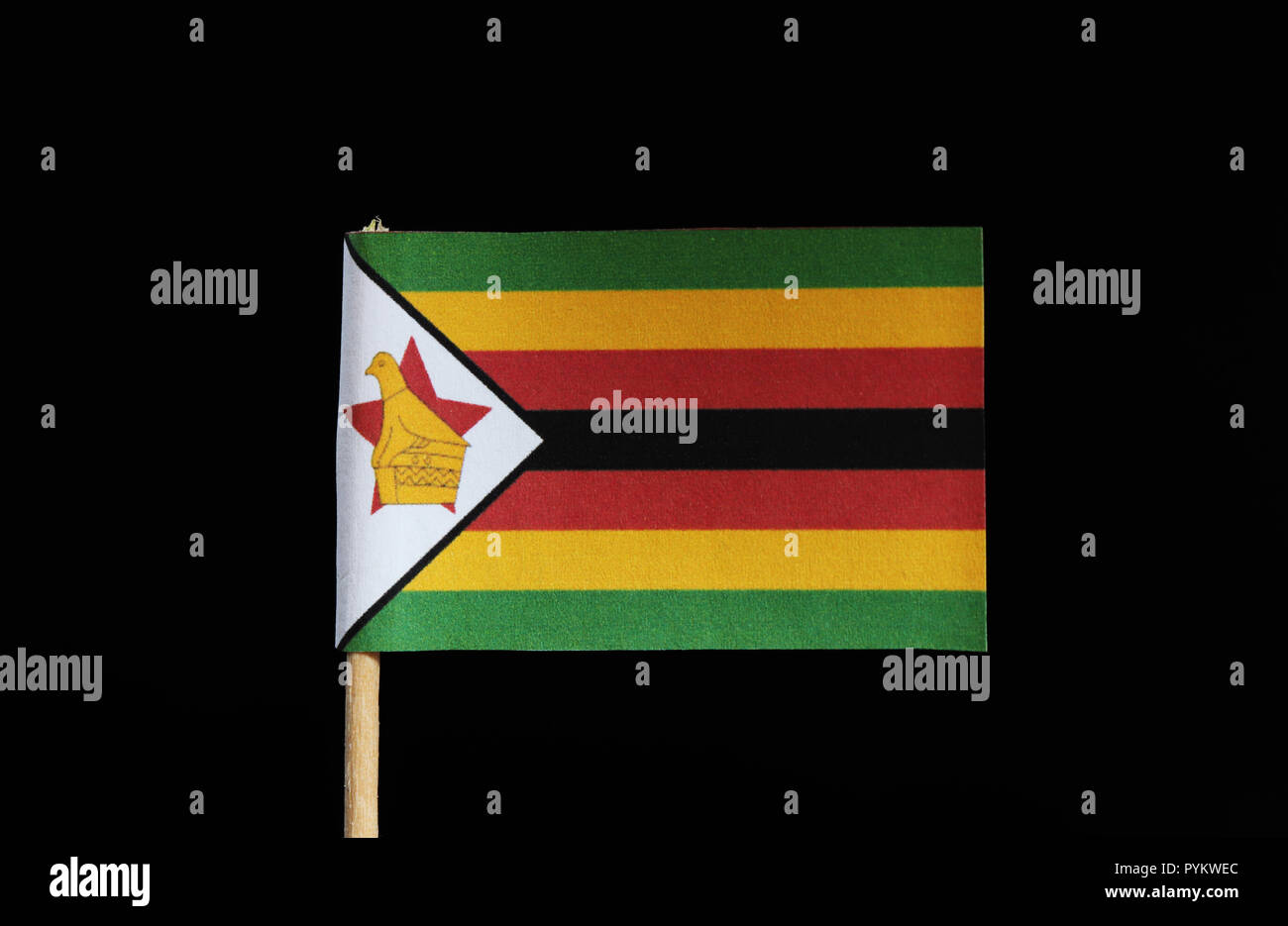 A national flag of Zimbabwe on toothpick on black background. Flag ...