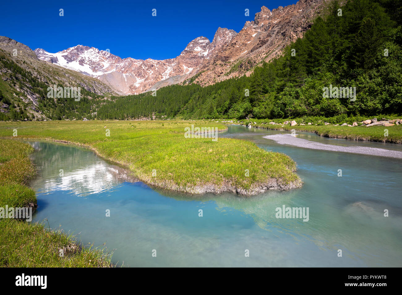 Mount Disgrazia is mirrored in a river. Predarossa valley, Valmasino ...