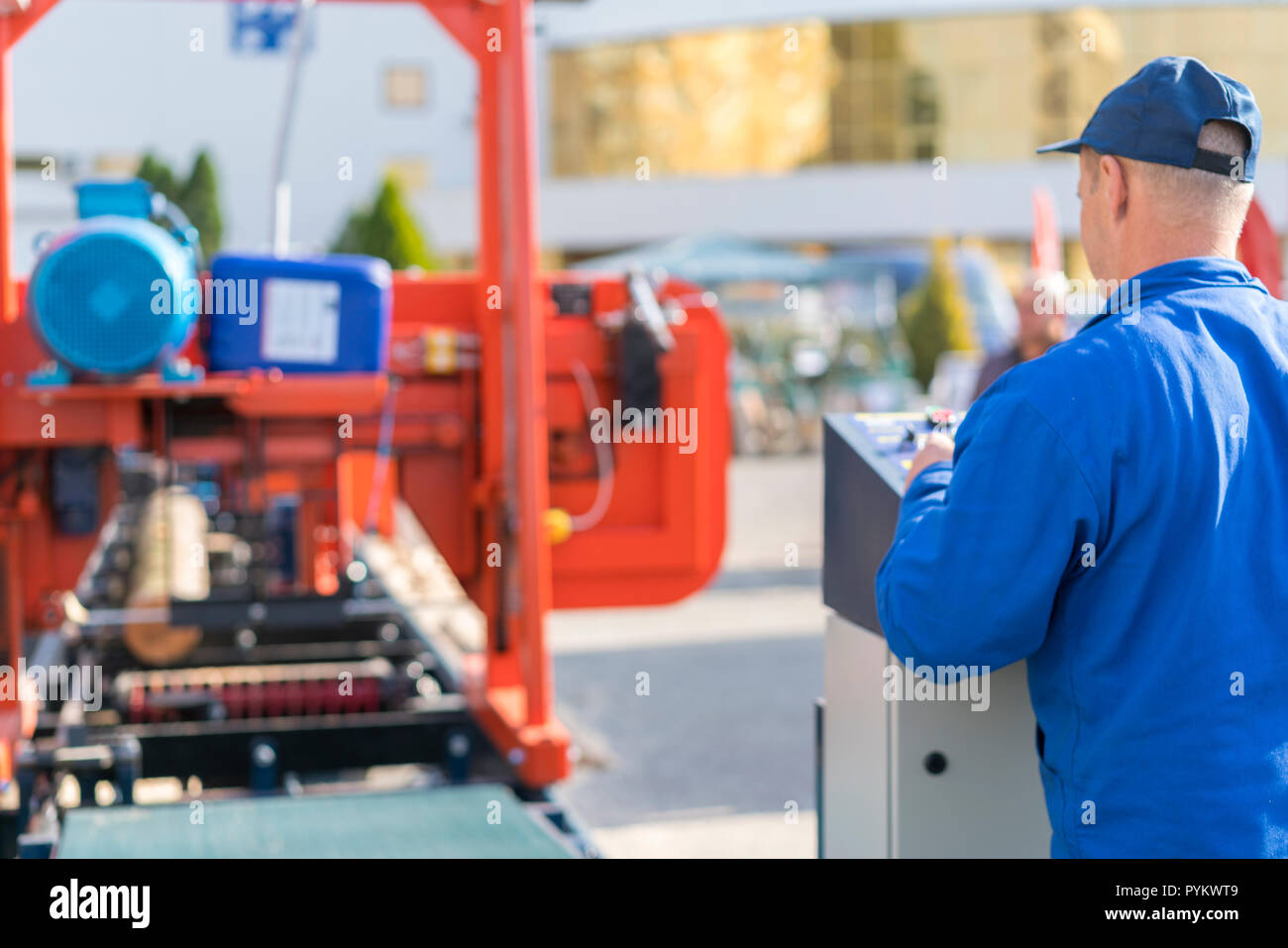 Worker pressing buttons on CNC machine control board in factory Stock ...