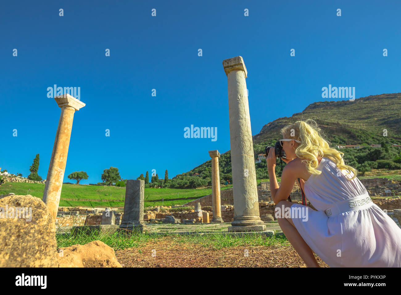 Travel woman photographer takes shot of Doric Propylon in Ancient ...