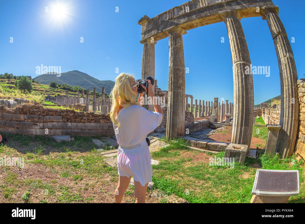 Travel photographer with reflex at woman Doric Propylon in Ancient ...