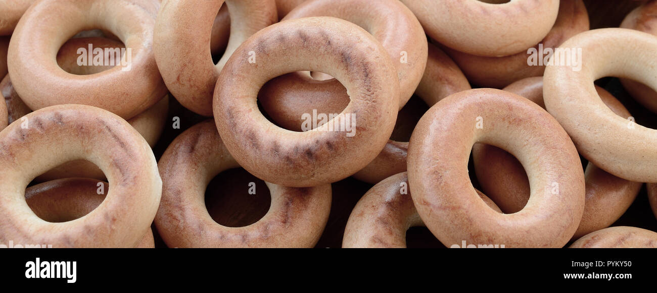 Close-up photo of fresh yellow bagels. A popular kind of flour products ...