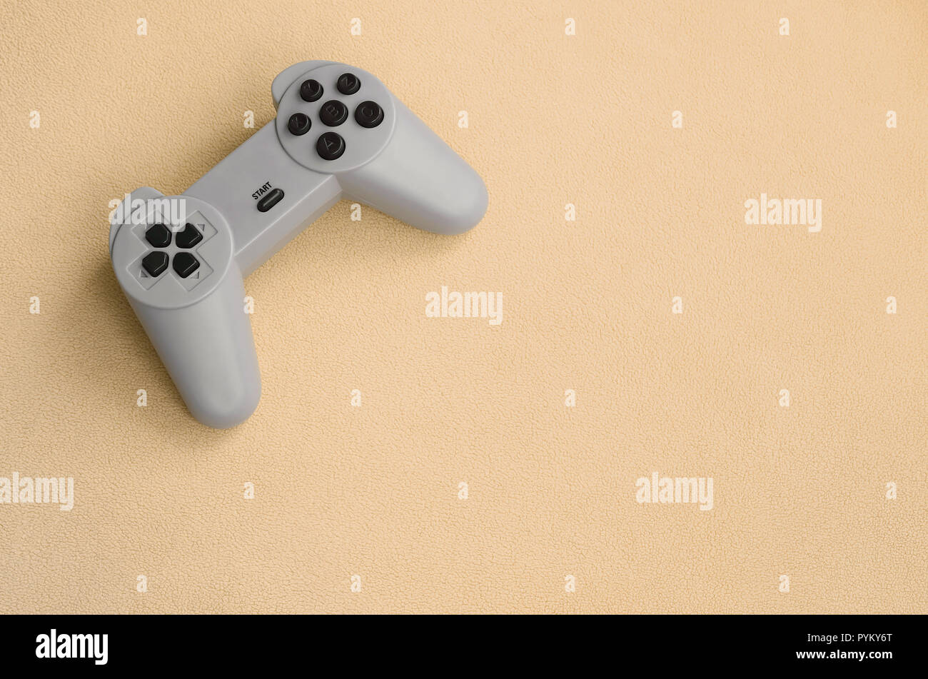 Playing games concept. Single pad joystick lies on the blanket of furry ...