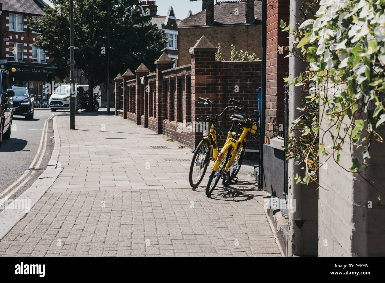 London, UK - August 1, 2018: Yellow Ofo bikes on a street in London ...