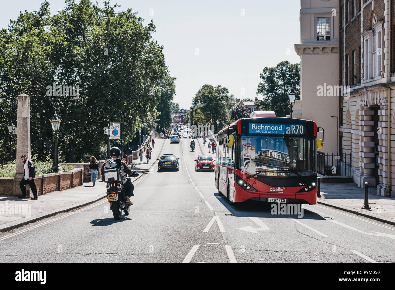 Red bus on route R70 bus on the street in Richmond, a suburban town on ...
