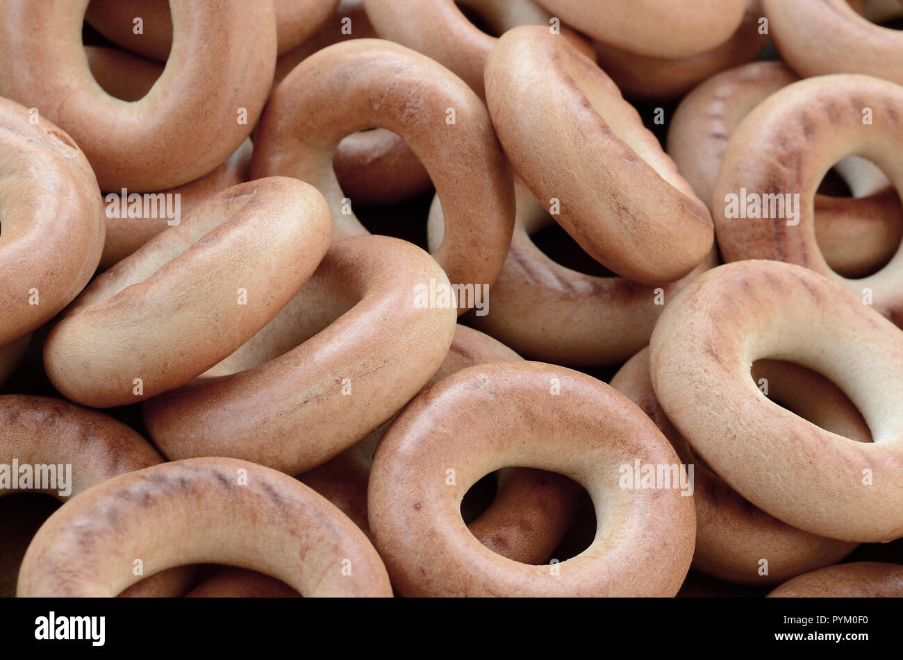 Close-up photo of fresh yellow bagels. A popular kind of flour products ...
