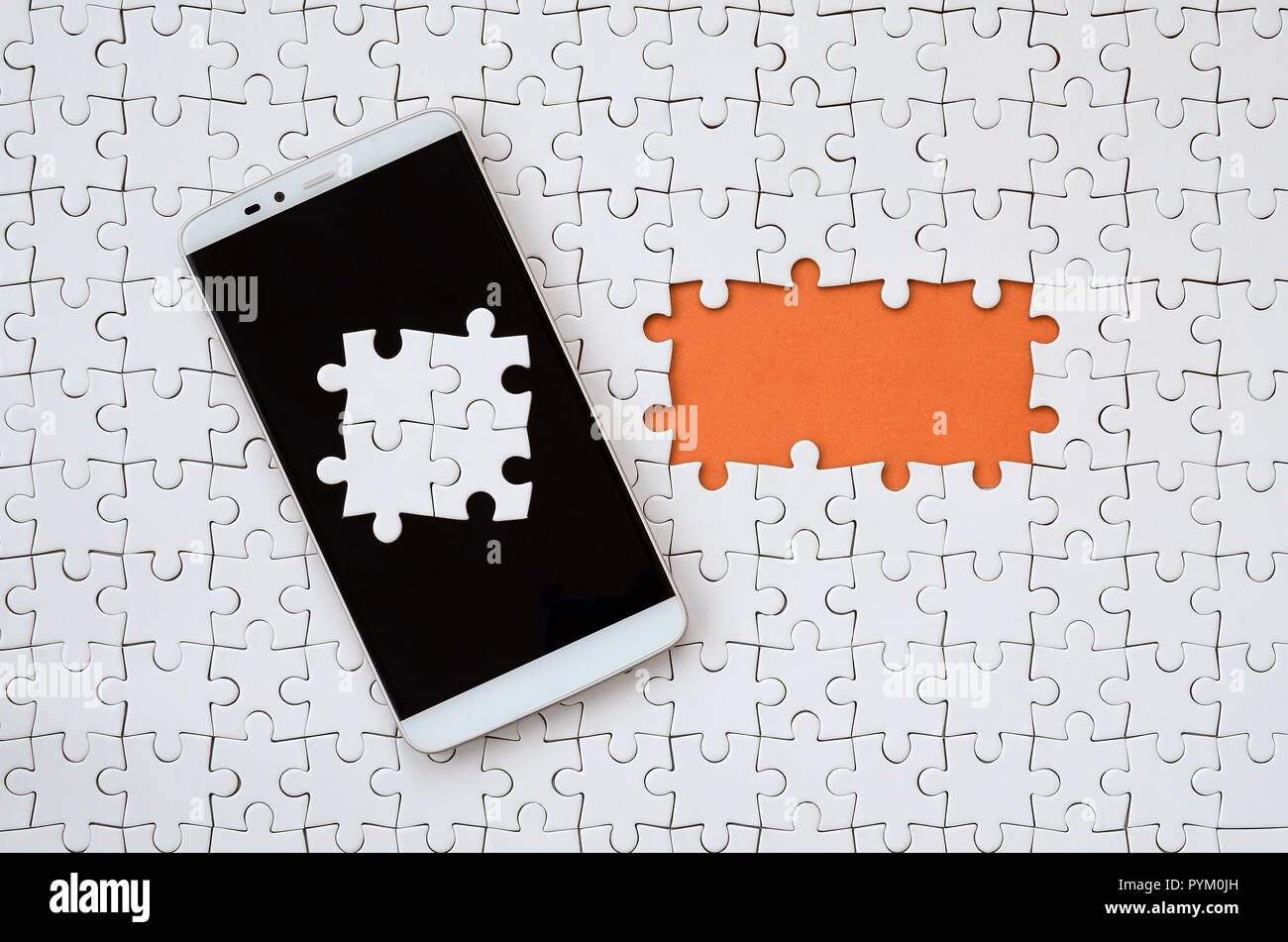 A modern big smartphone with several puzzle elements on the touch ...