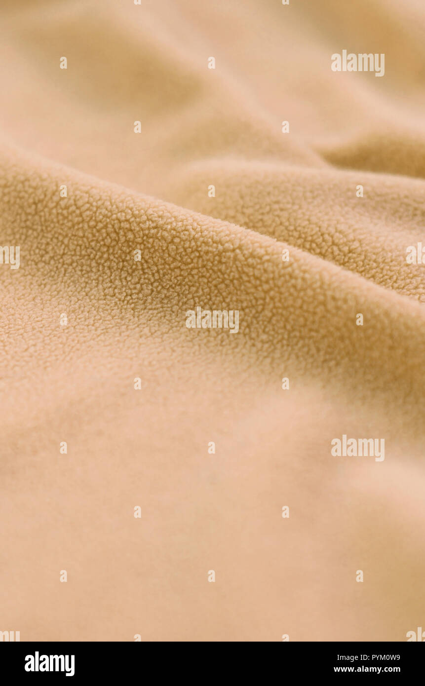 The blanket of furry orange fleece fabric. A background of light orange ...