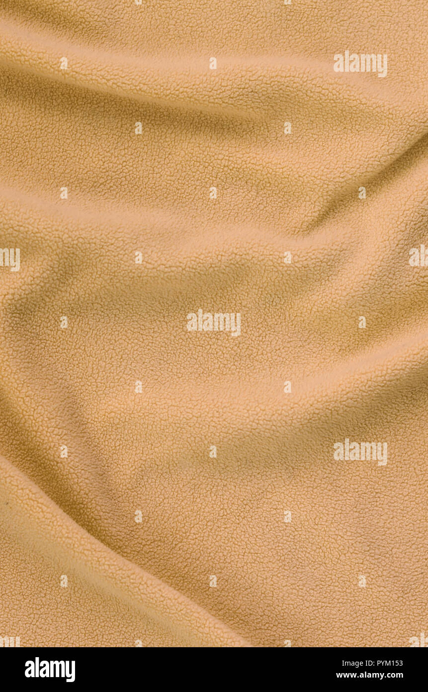 The blanket of furry orange fleece fabric. A background of light orange ...