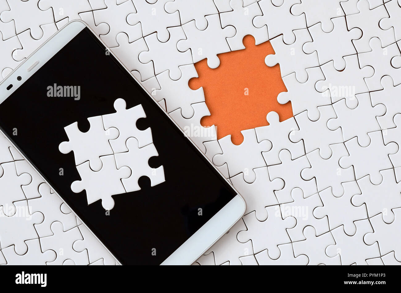 A modern big smartphone with several puzzle elements on the touch ...
