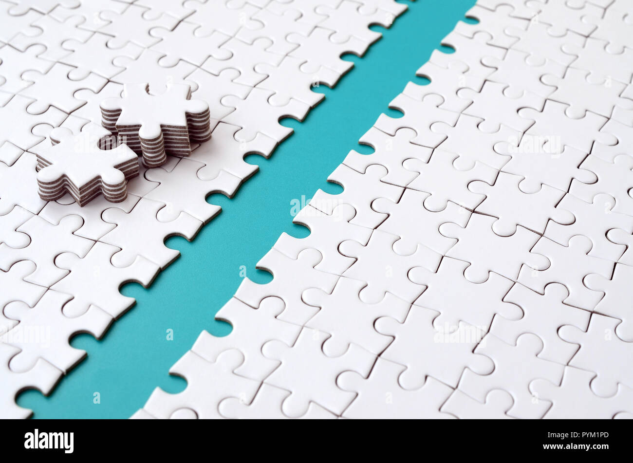 The blue path is laid on the platform of a white folded jigsaw puzzle ...