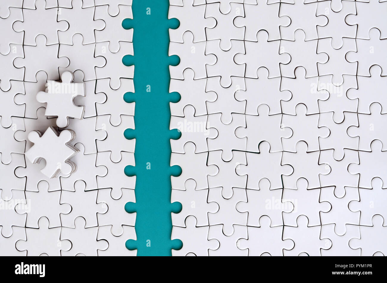 The blue path is laid on the platform of a white folded jigsaw puzzle ...