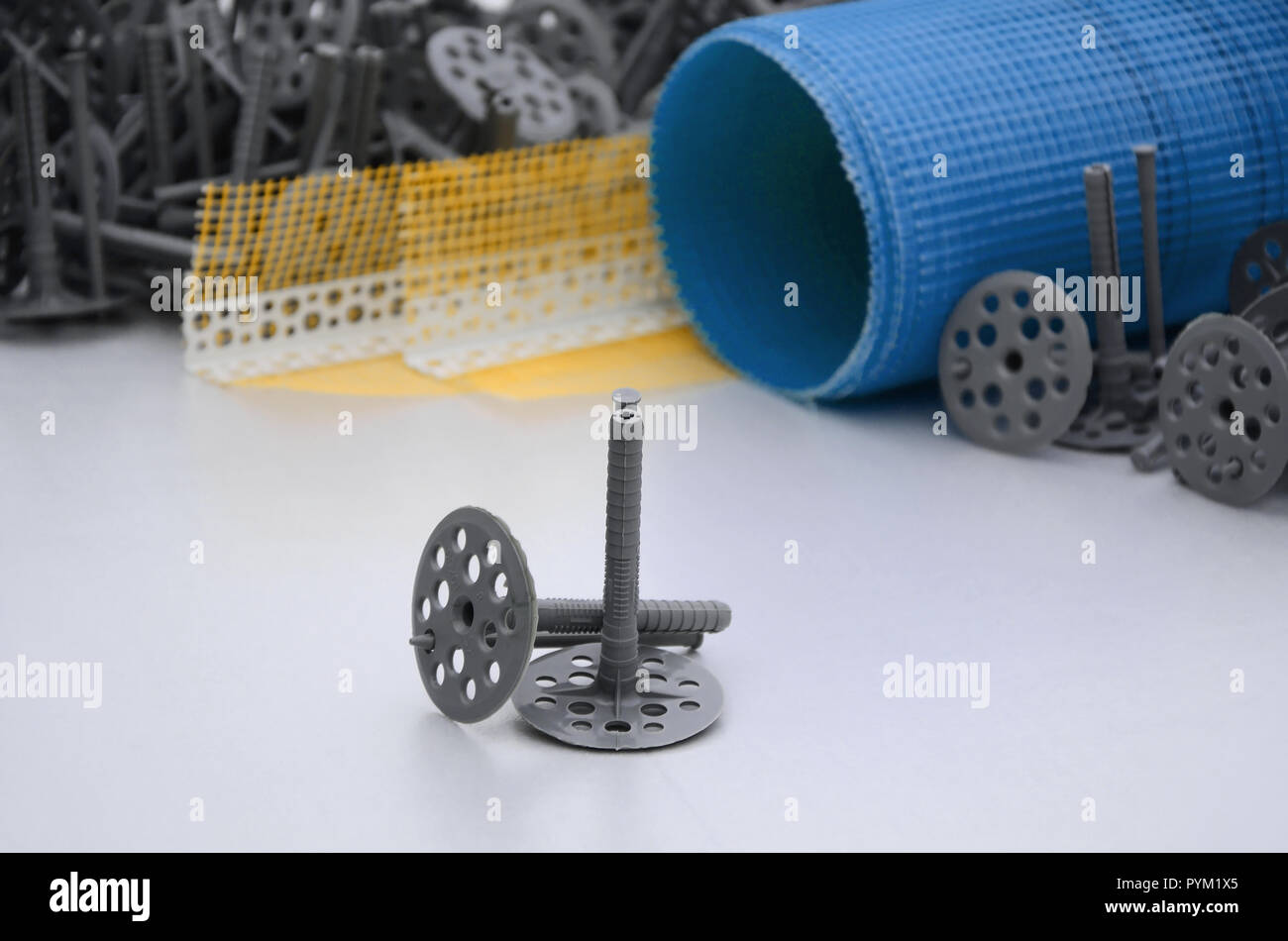 A set of construction items for the insulation of walls. Plastic dowels ...