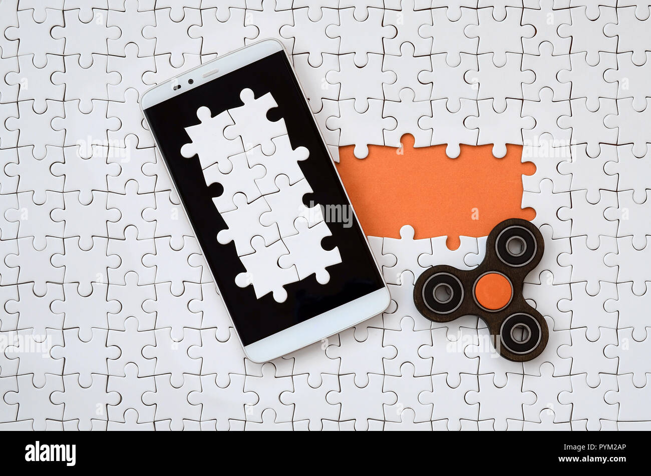 A modern big smartphone with a touch screen and a spinner lie on a ...