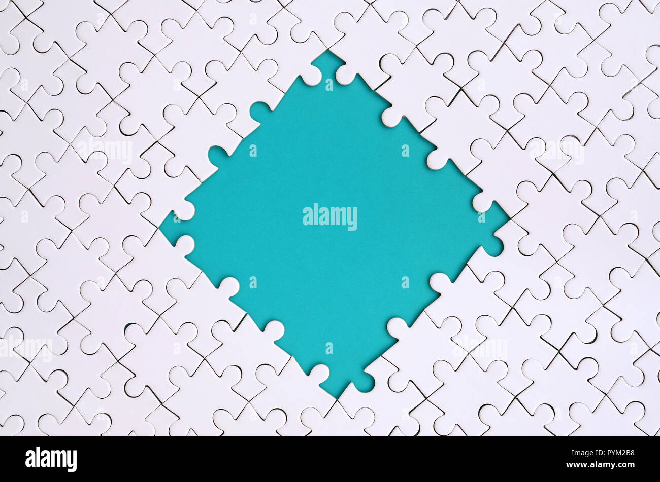 Framing in the form of a rhombus, made of a white jigsaw puzzle around ...