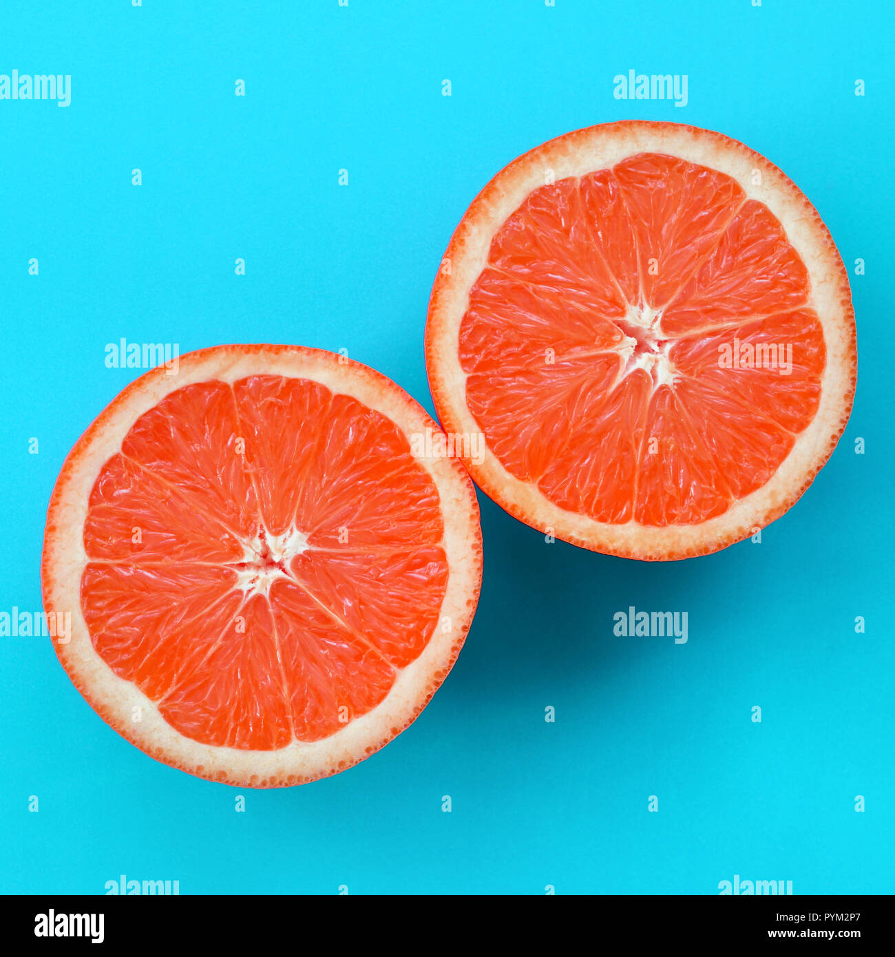 Top view of a several grapefruit slices on bright background in blue ...