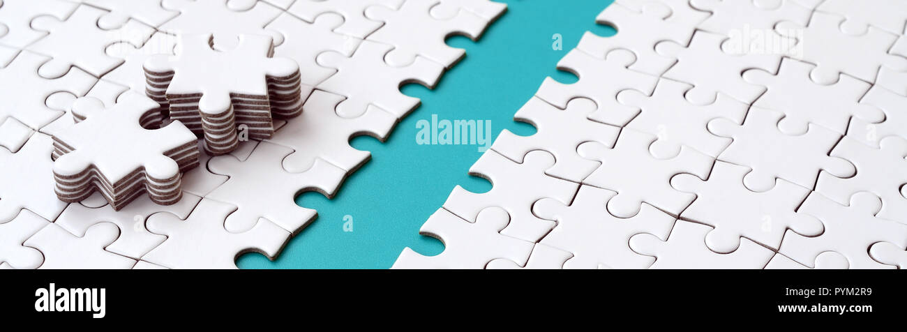 The blue path is laid on the platform of a white folded jigsaw puzzle ...