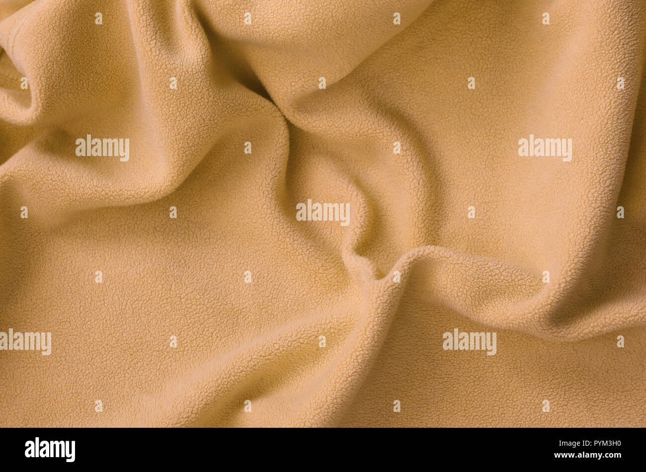 The blanket of furry orange fleece fabric. A background of light orange ...