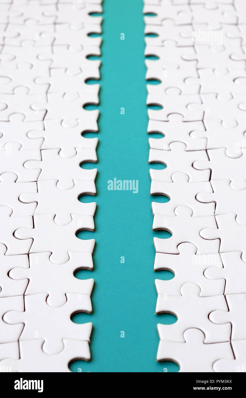 The blue path is laid on the platform of a white folded jigsaw puzzle ...