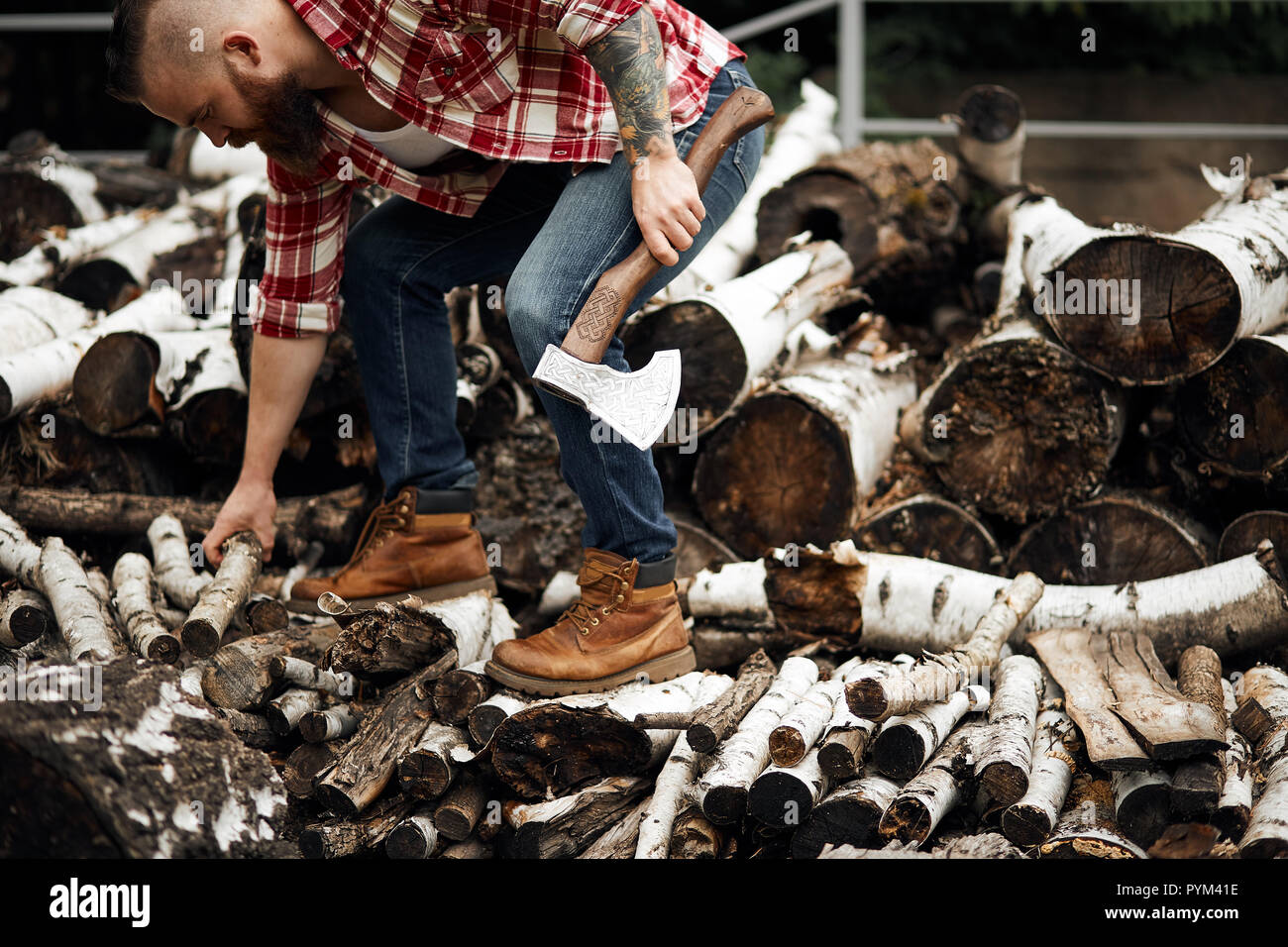 bearded mohawk Man choise firewoods for fireplace Stock Photo - Alamy
