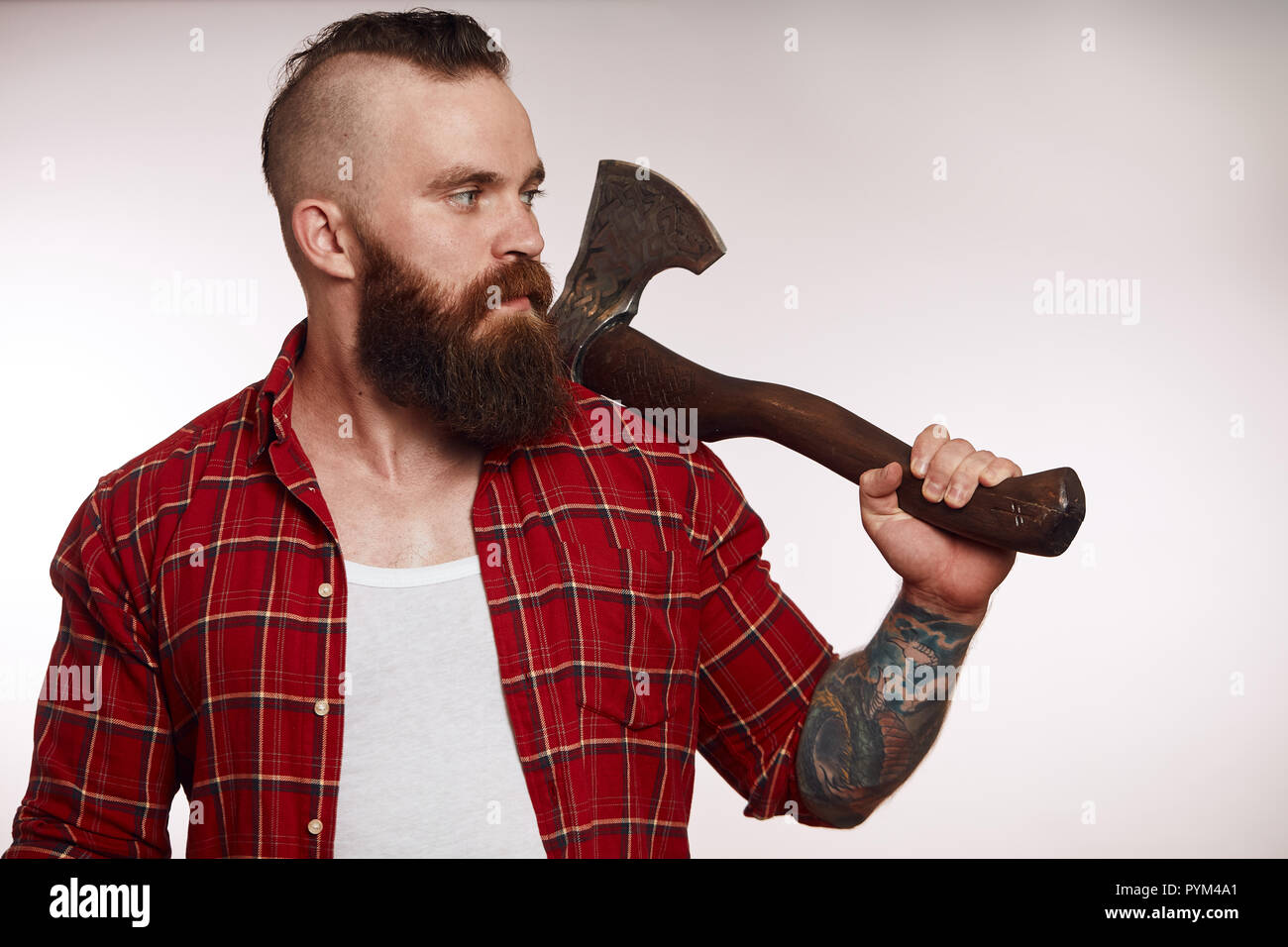 mohawk bearded male holds axe on his shoulder on white background Stock ...