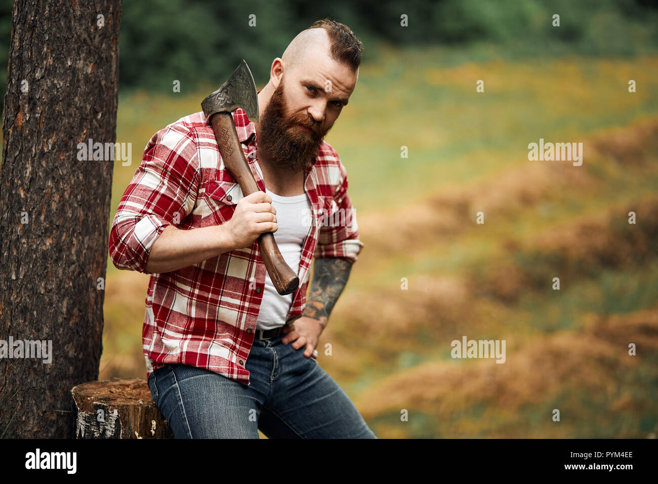 Lumberjack sitting in forest resting after hard work Stock Photo - Alamy