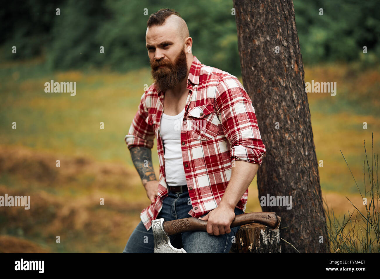 Lumberjack sitting in forest resting after hard work Stock Photo - Alamy