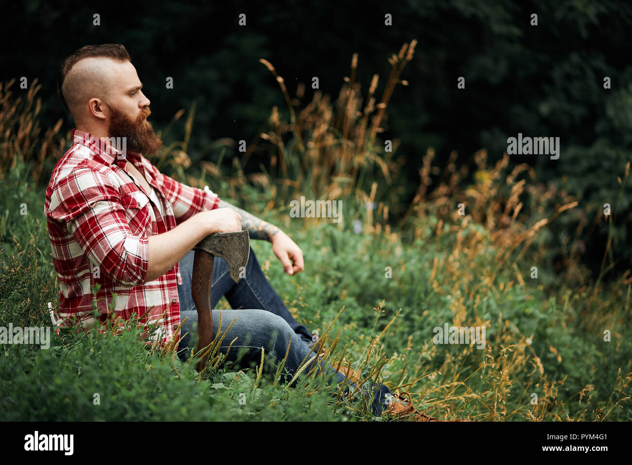 Lumberjack sitting in forest resting after hard work Stock Photo - Alamy