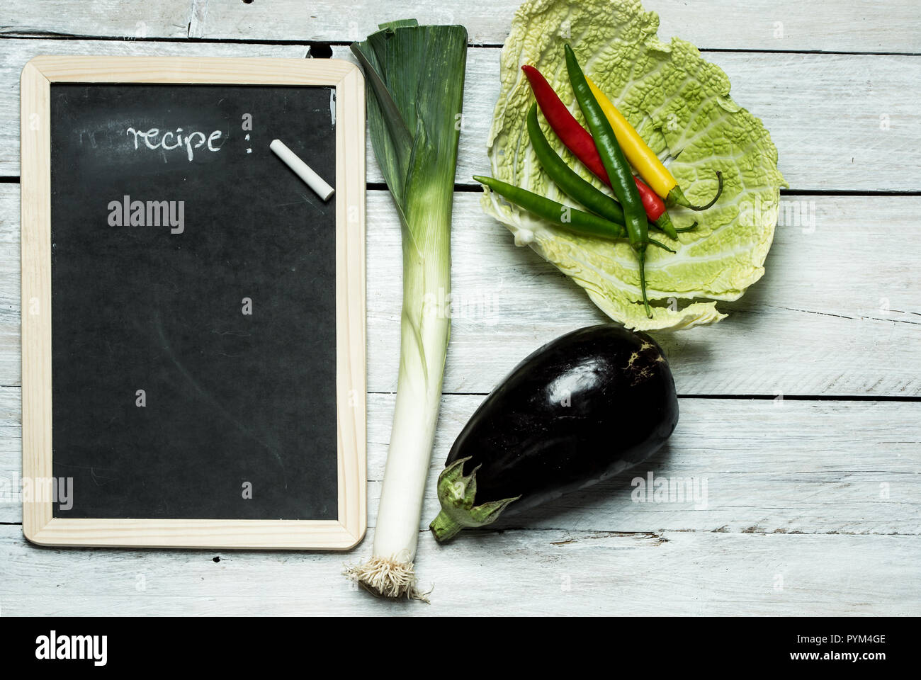 blackboard with the word "recipe" on white, rustic wooden background ...