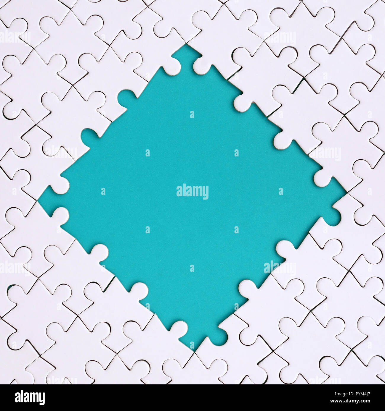 Framing in the form of a rhombus, made of a white jigsaw puzzle around ...