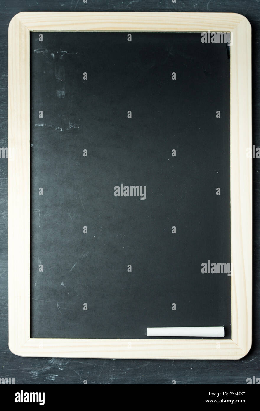 Empty black chalkboard with white chalk on white, rustic wooden wall ...