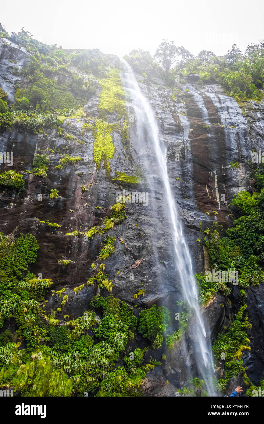 Waterfall in Milford Sound lake landscape, New Zealand Stock Photo - Alamy