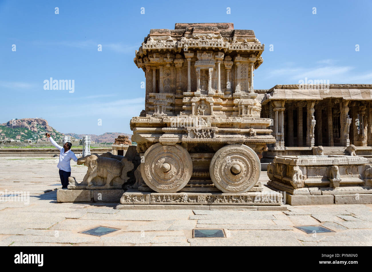 A man clicks selfie in front of the richly sculpted Stone Chariot in ...