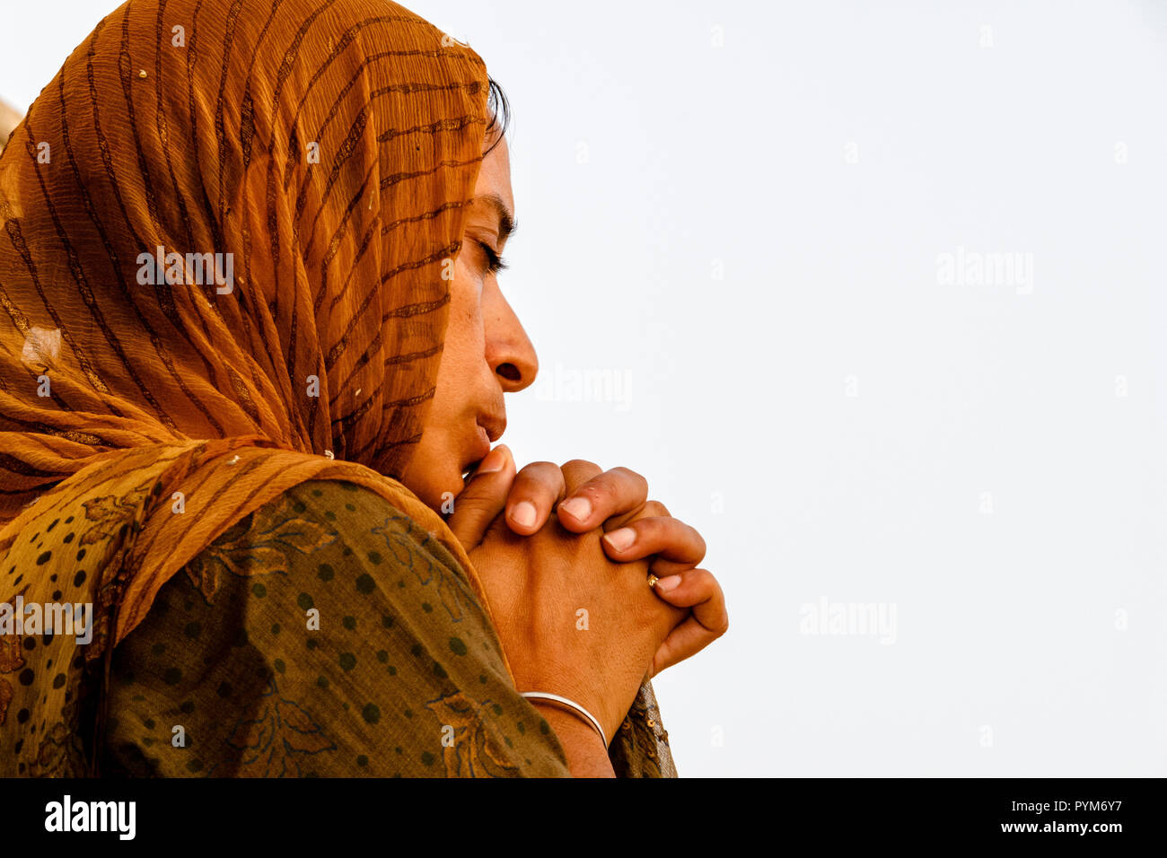 Sikh devotee praying in front of the Golden Temple after a long journey ...