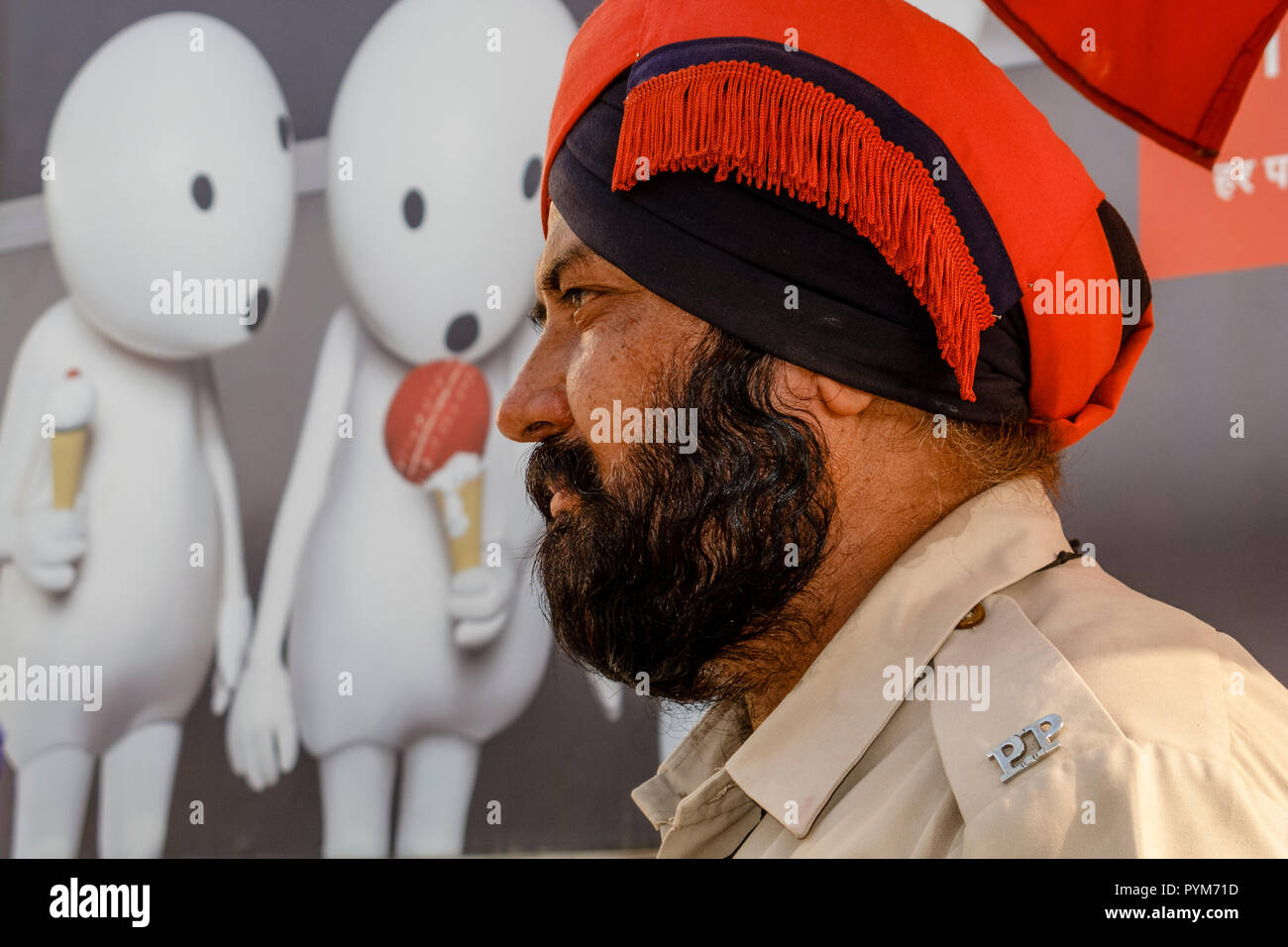 Policeman in Amritsar in front of a funny commercial poster Stock Photo ...
