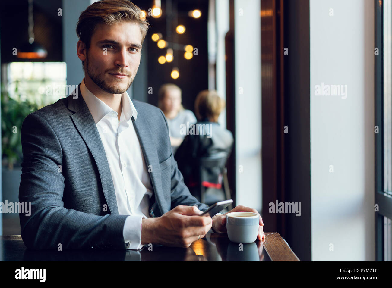 Business man drinking coffee in a cafe - coffee time Stock Photo - Alamy