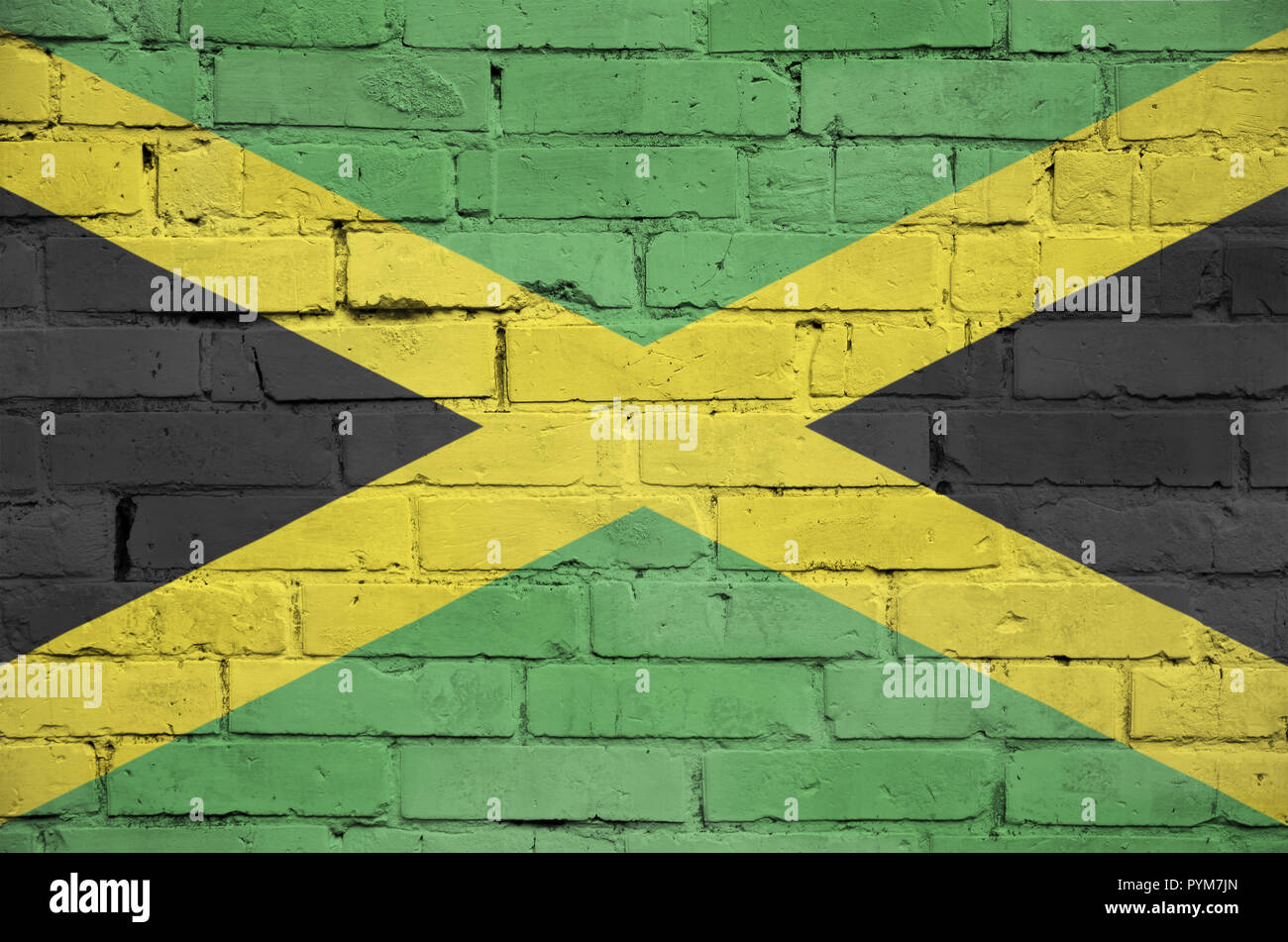 Jamaica flag is painted onto an old brick wall Stock Photo - Alamy