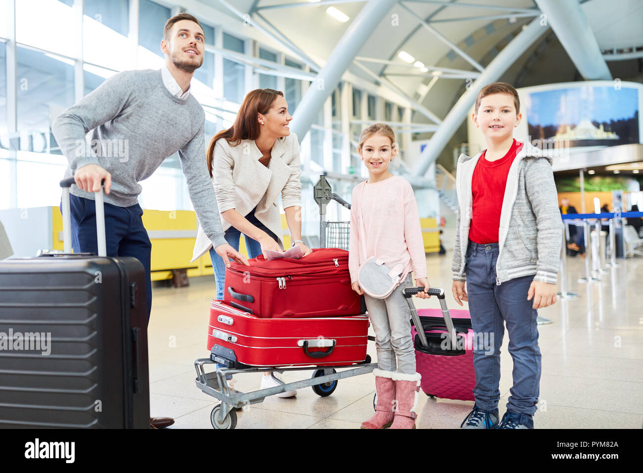 Man woman family children luggage hi-res stock photography and images ...