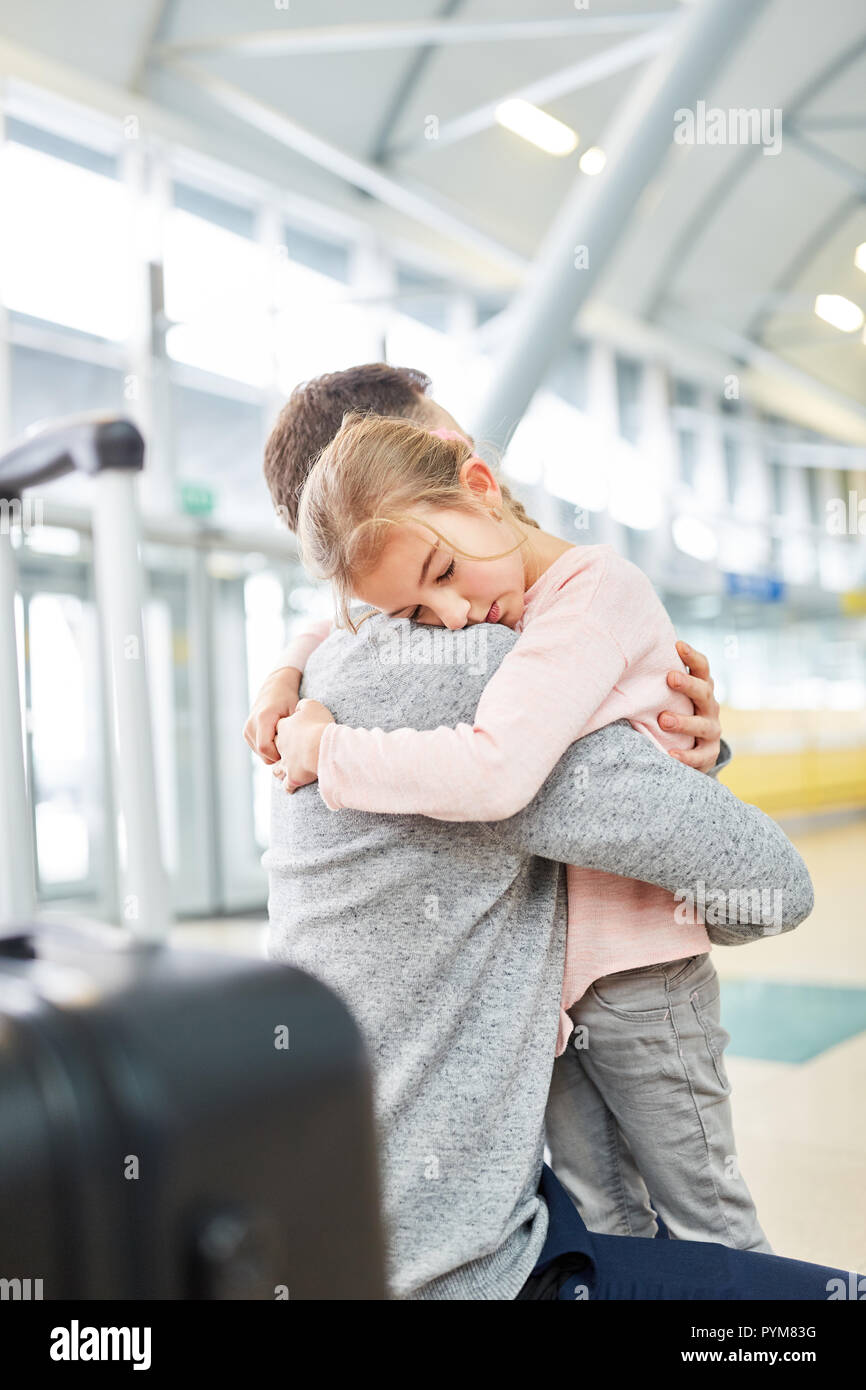Little girl hugs her dad at the airport terminal to say goodbye before ...