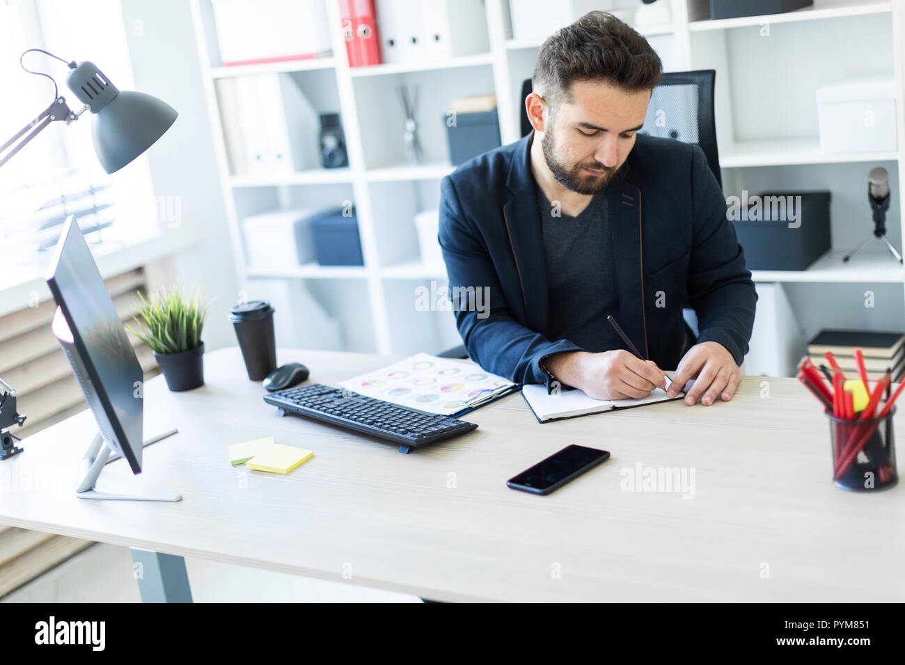 Businessman sitting desk diagrams hi-res stock photography and images ...