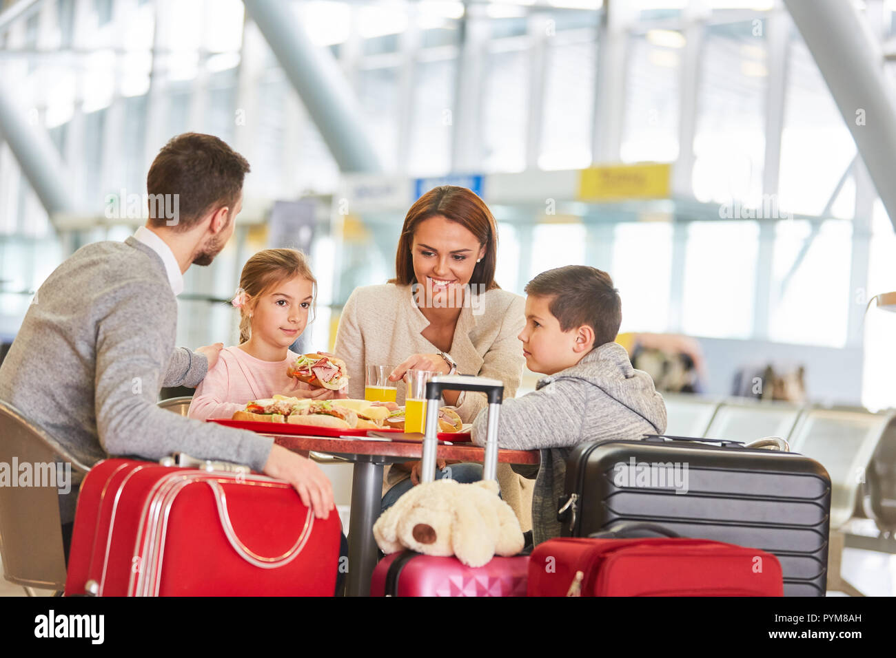 Family with children eat snacks together in the restaurant before ...