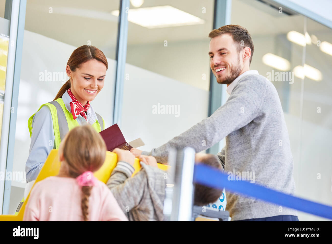 Service clerk at the check-in desk in the terminal checks passport and ...