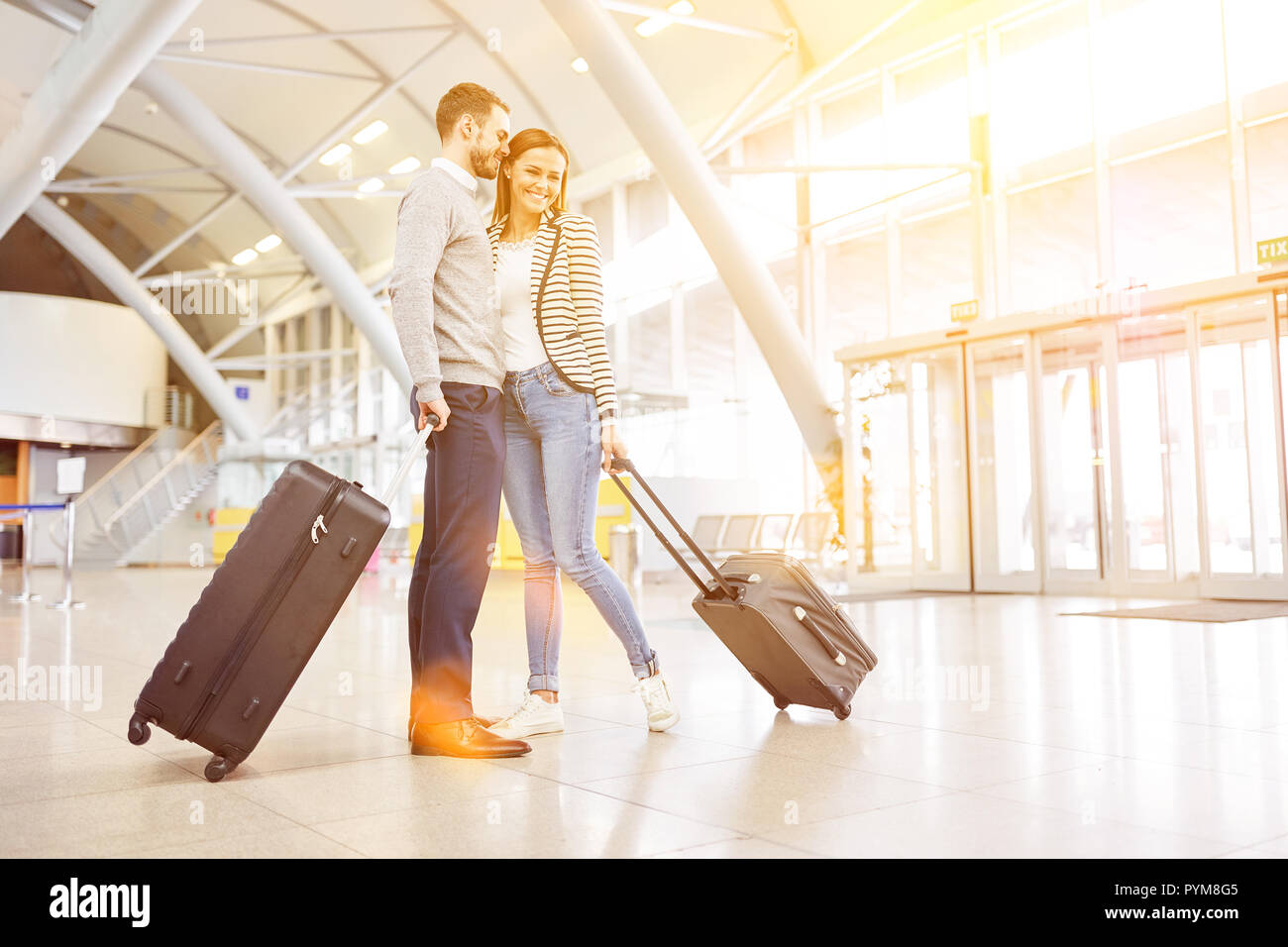 Airport man woman luggage hi-res stock photography and images - Alamy
